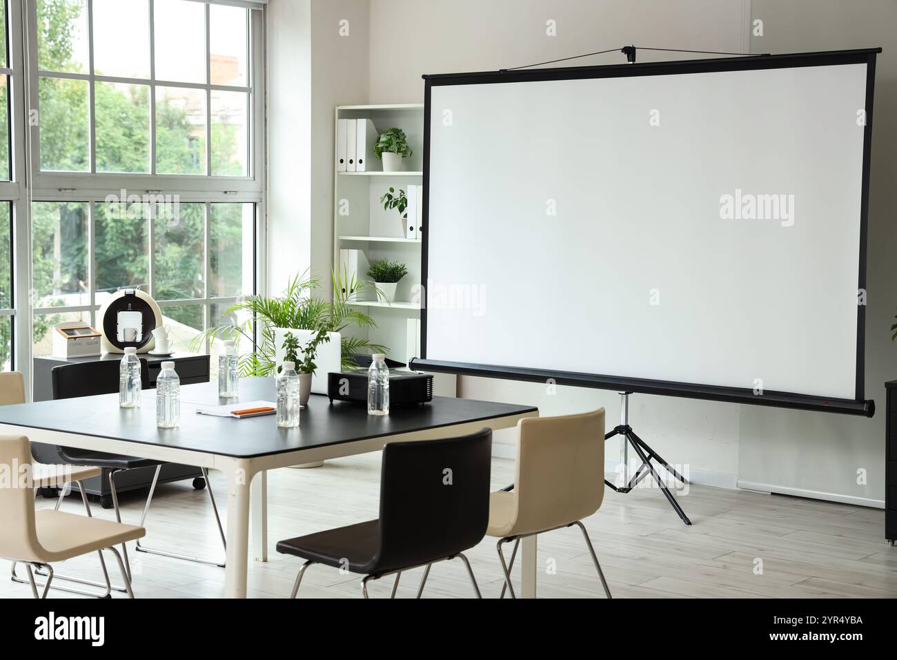 Interior of office with projector screen and meeting table Stock Photo ...
