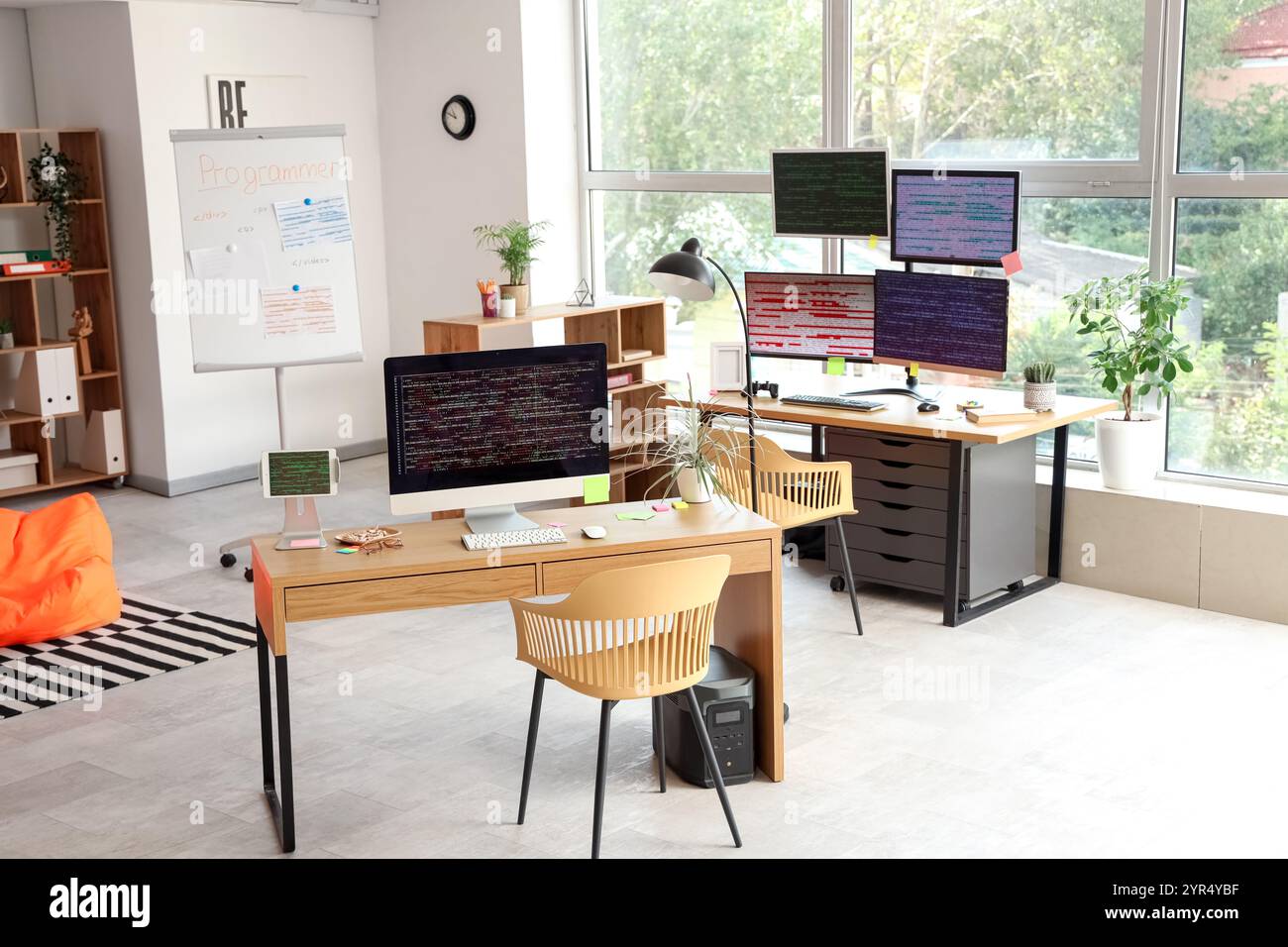 Interior of light programmer's office with desks, shelf units and ...