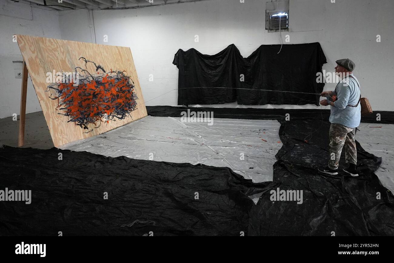 Artist Ben Miller creates a painting using a fly fishing rod ...