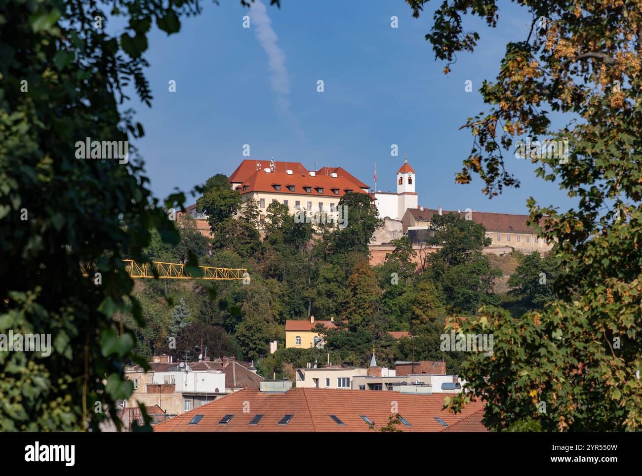 A picture of the Spilberk Castle as seen from afar between trees Stock ...