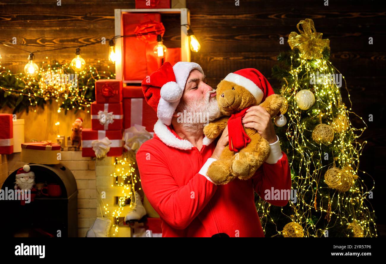 Merry Christmas and Happy New year. Smiling Santa Claus kisses plush ...