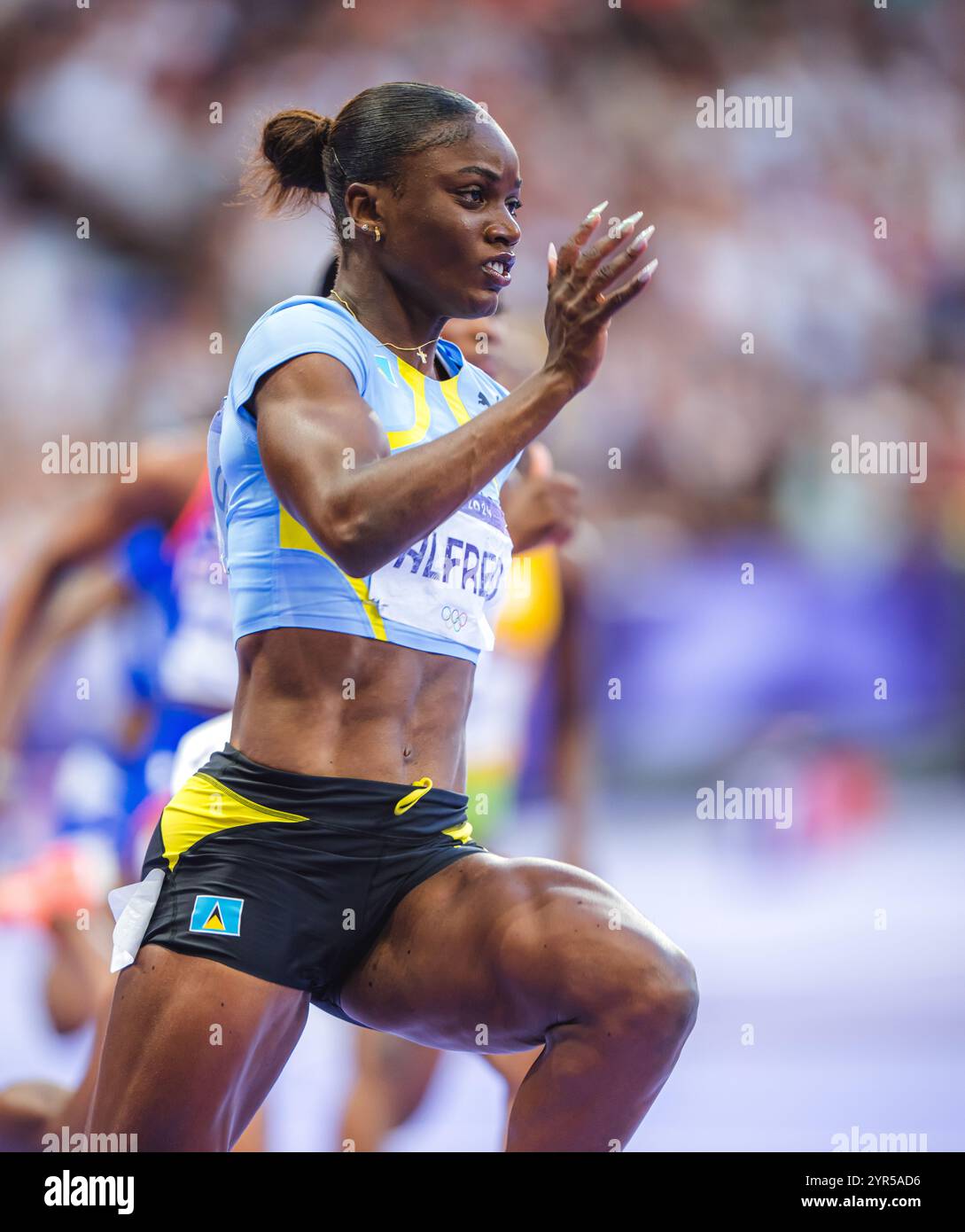 Julien Alfred participating in the 200 meters relay at the Paris 2024 ...