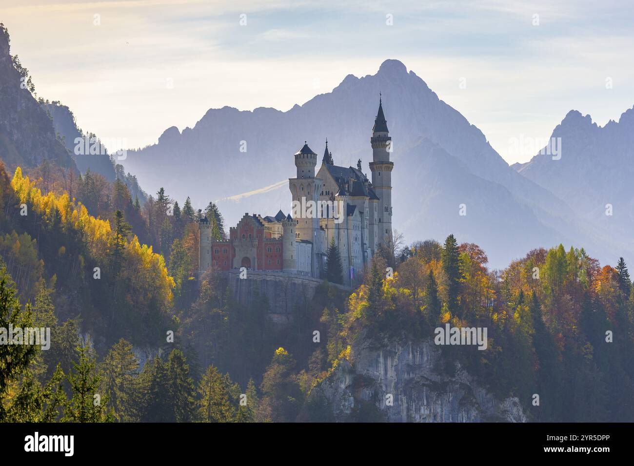 Sublime castle with towers in an autumnal coloured mountain landscape ...