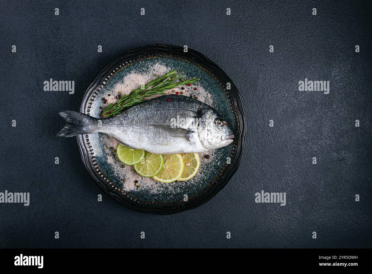 Fresh, raw dorado fish, on a dark blue background, top view, two pieces ...