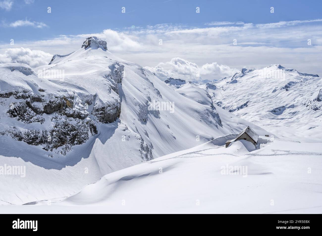 Snow-covered hut in winter, mountain landscape with snow, behind summit ...