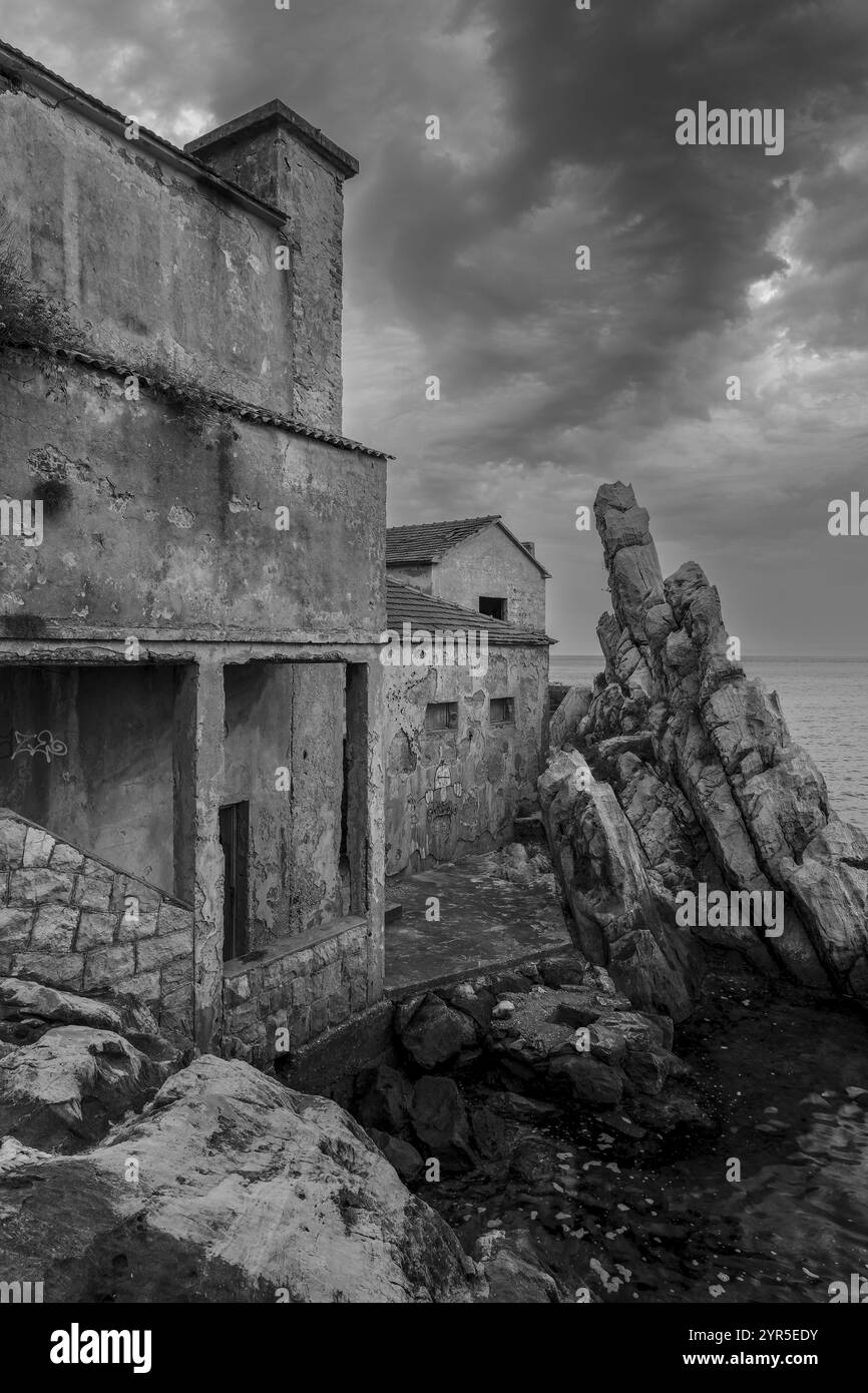Lost Place, Abandoned ruined building by the sea under dramatic clouds ...
