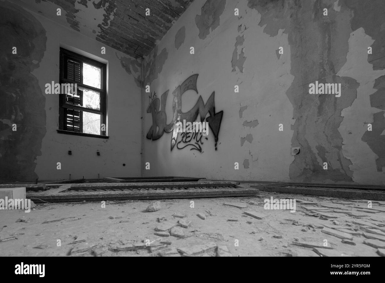 Empty room with graffiti and peeling walls, destruction visible, broken ...