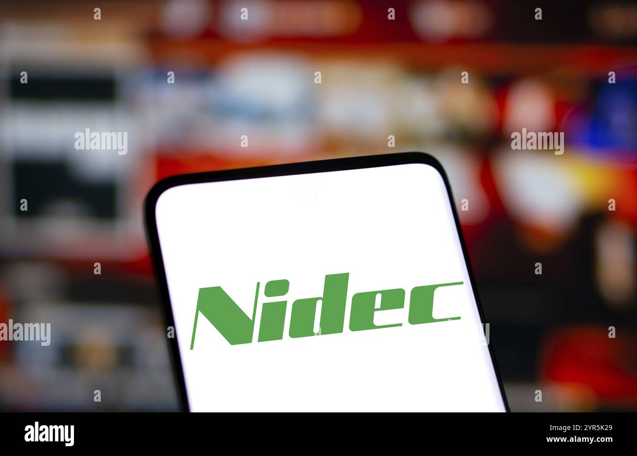 Nidec logo is displayed on smartphone. Nidec Corporation is a Japanese ...