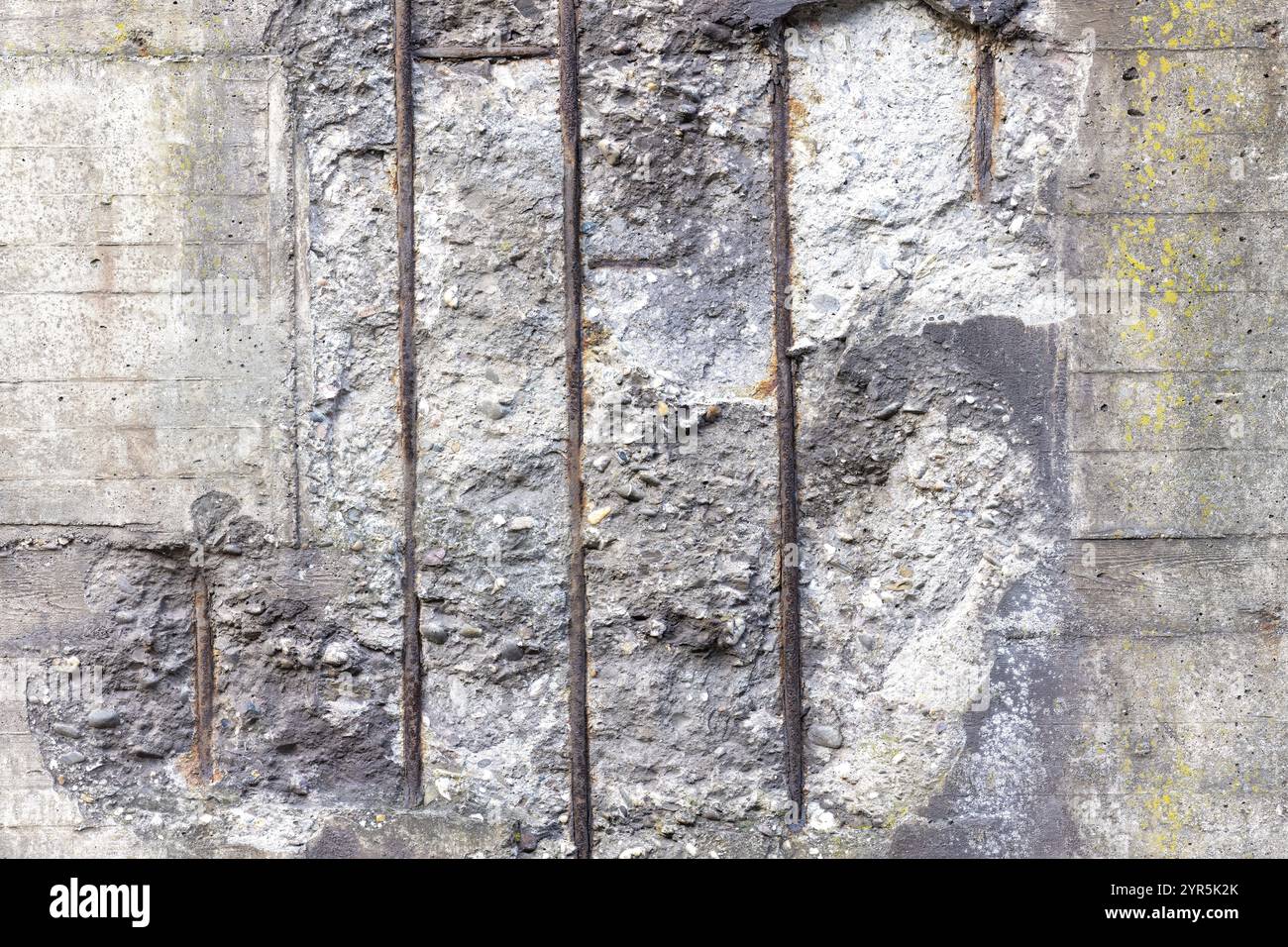 Decaying concrete wall with exposed rebar and weathered surface Stock ...
