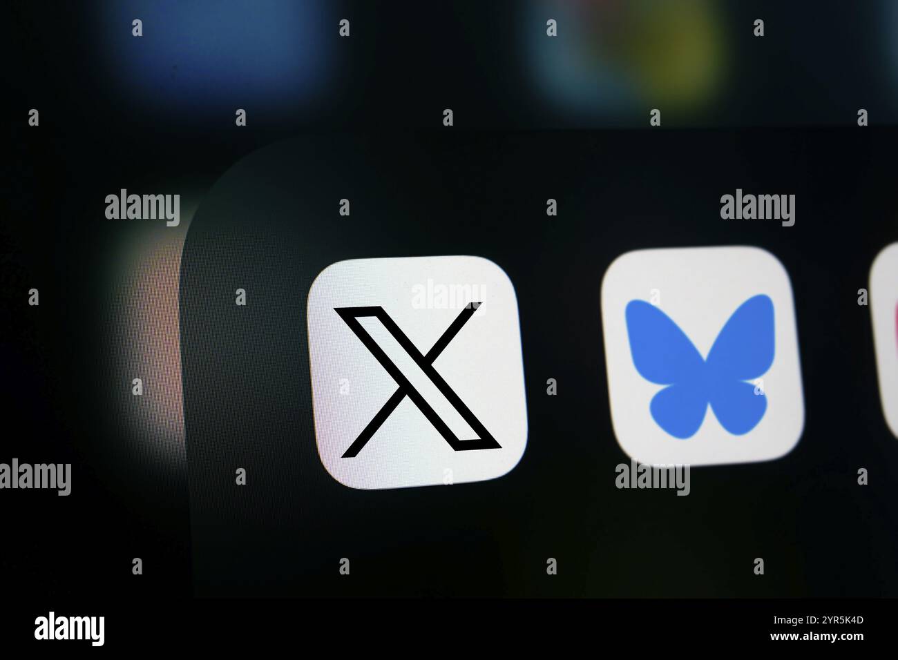 A close up of an iPhone screen displaying the X (twitter) app icon and ...