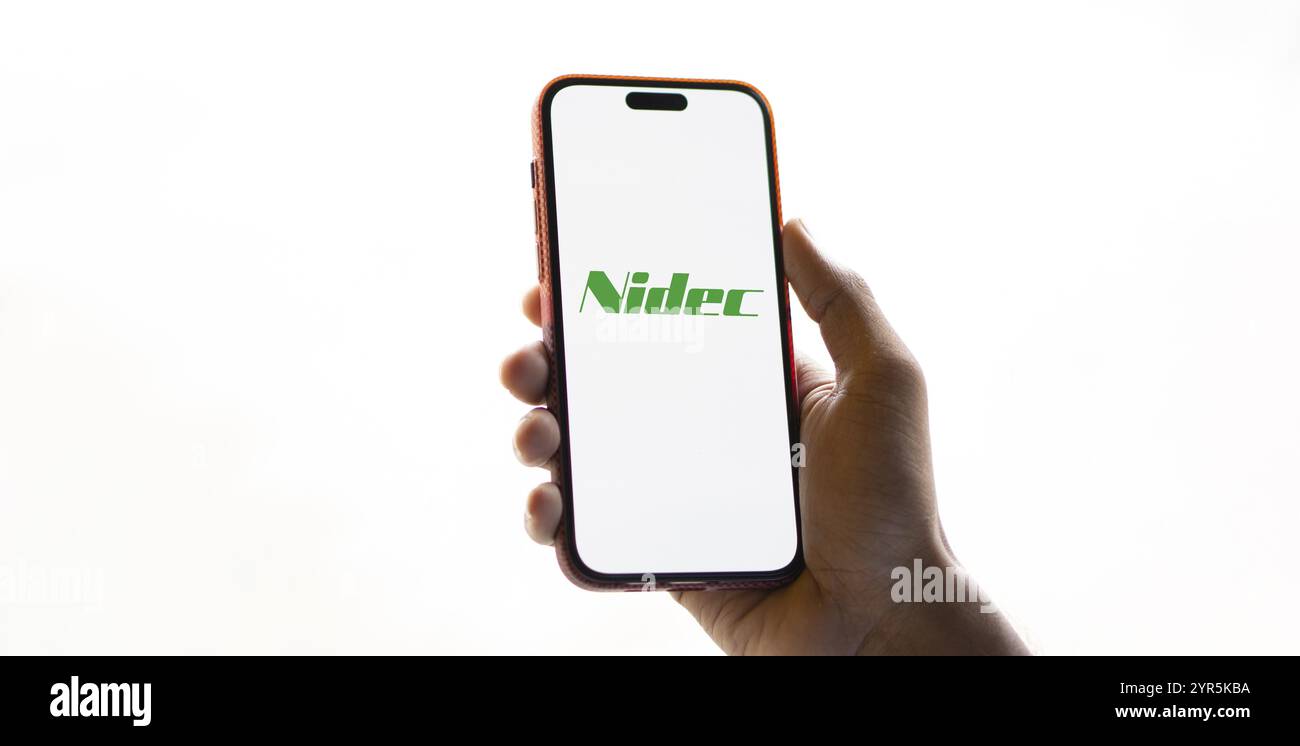 Nidec logo is displayed on smartphone. Nidec Corporation is a Japanese ...