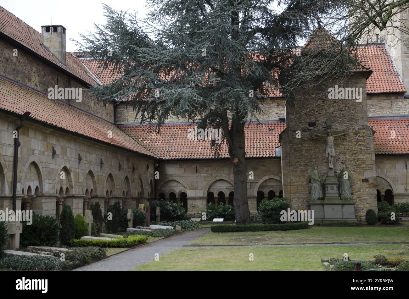 Monastery courtyard with red tiled roof and large statue surrounded by ...