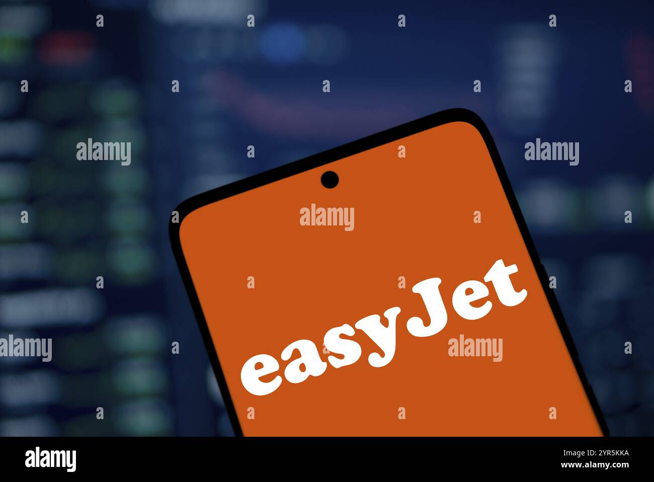 EasyJet logo is displayed on smartphone. EasyJet plc is a British ...