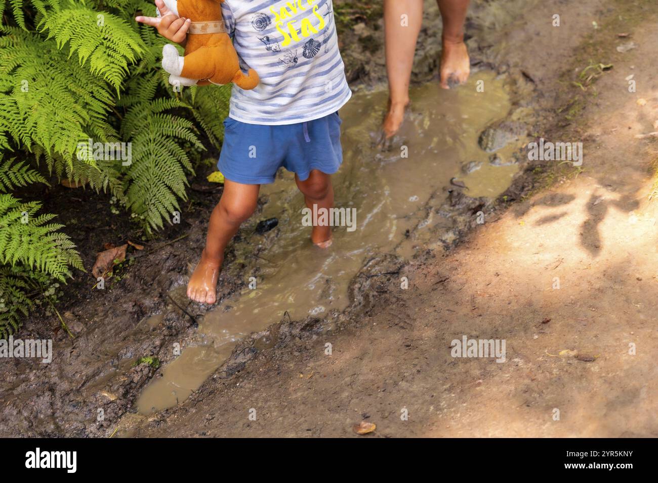 Barefoot through mud and water in a sensory park to enjoy nature and ...