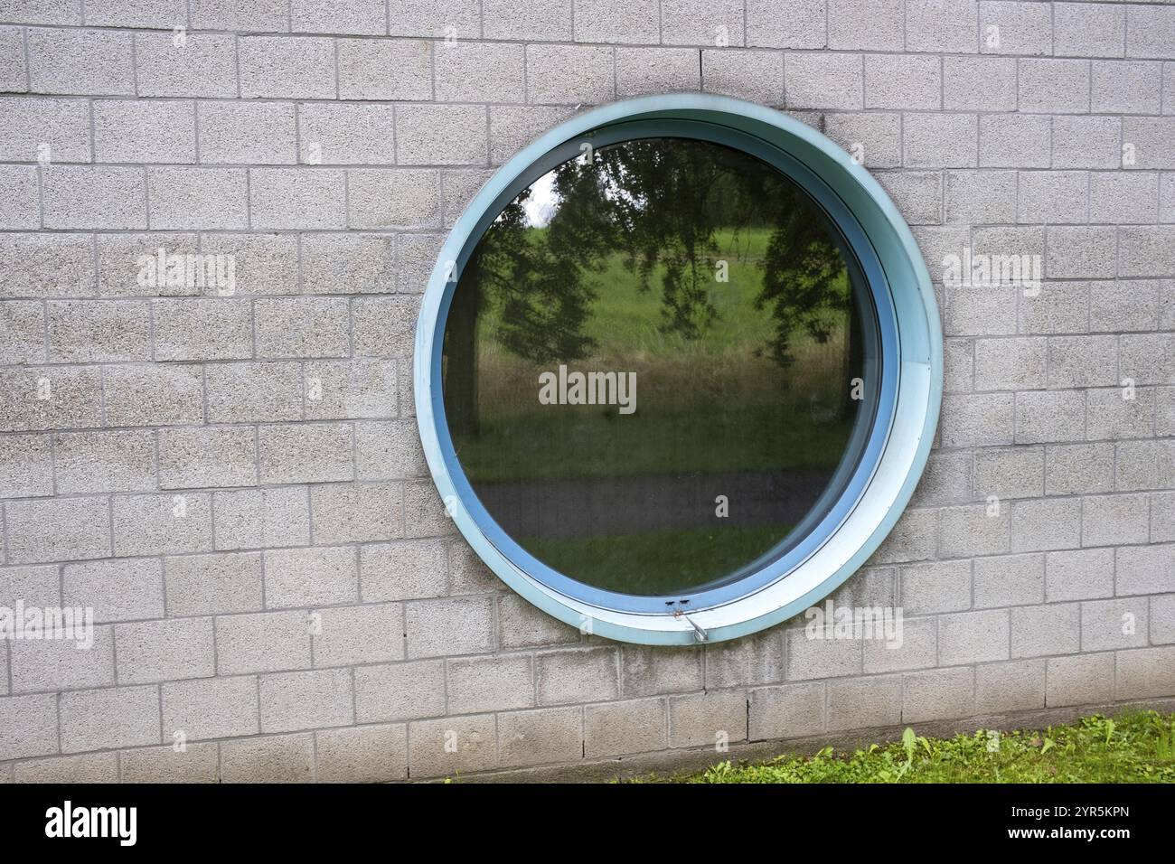 Round window in a concrete wall Stock Photo - Alamy