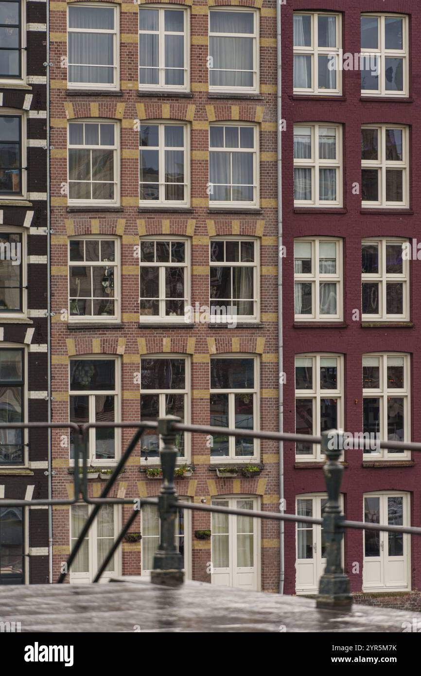 Rows of brick buildings with large windows in an urban environment ...
