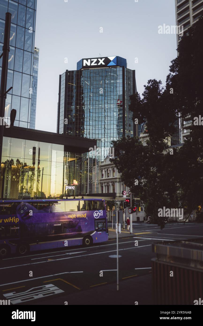 Modern glass building labelled NZX, surrounded by urban environment ...