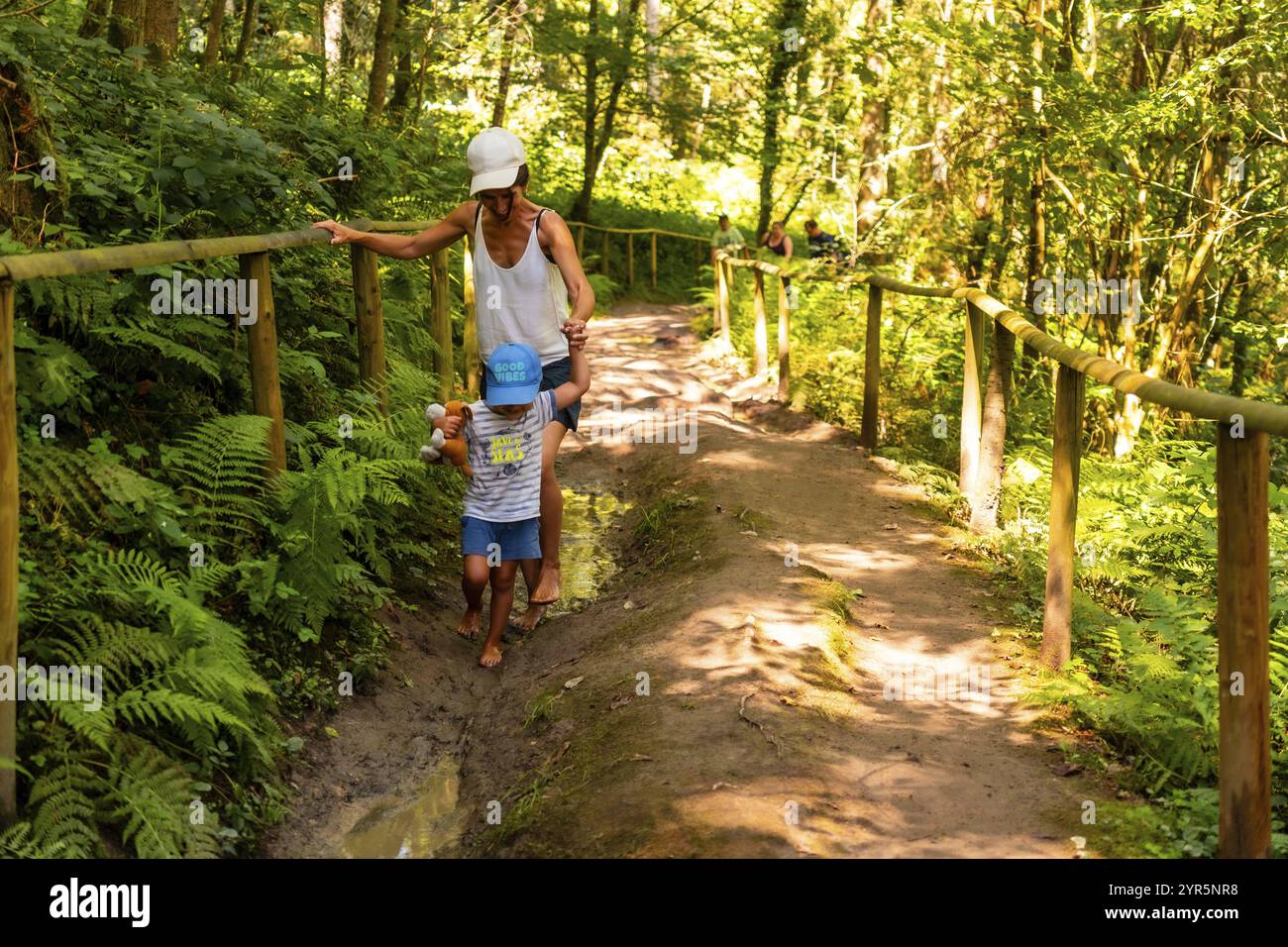 Walking barefoot through mud in a sensory park to enjoy nature and the ...