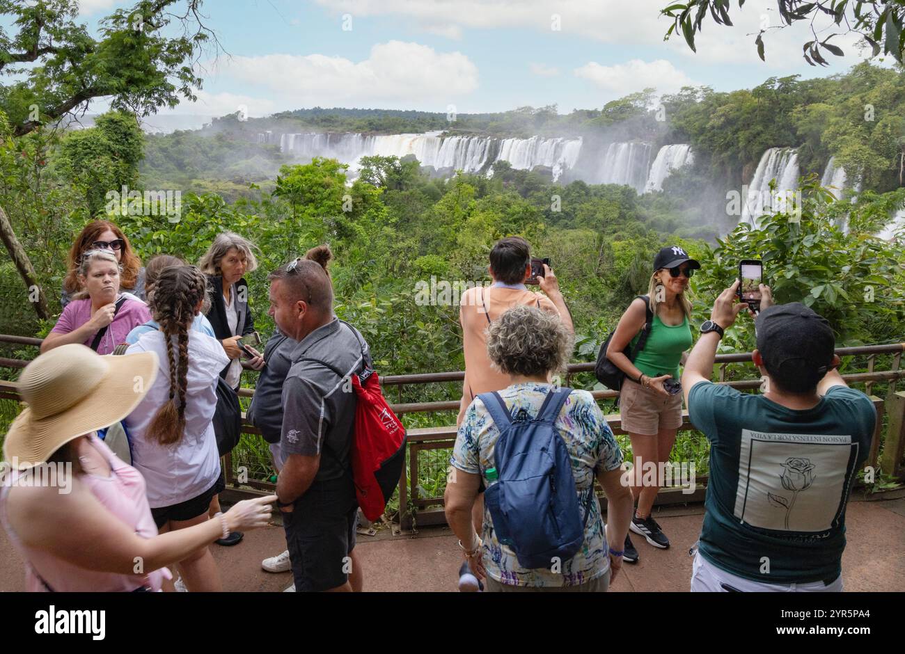 Iguazu falls tourists; visitors looking at the waterfalls from a ...