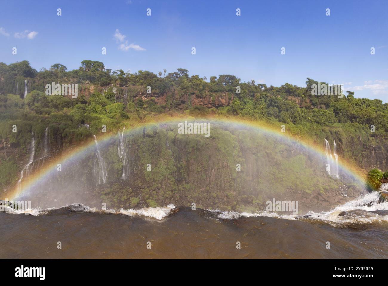 Iguazu Falls rainbow. A rainbow seen over the waterfalls on the Iguacu ...