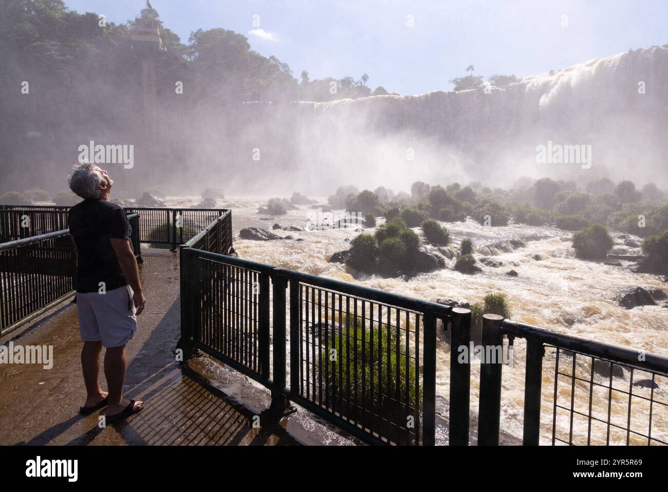 Brazil tourist. One man at the Iguazu Falls Brazil side of the ...