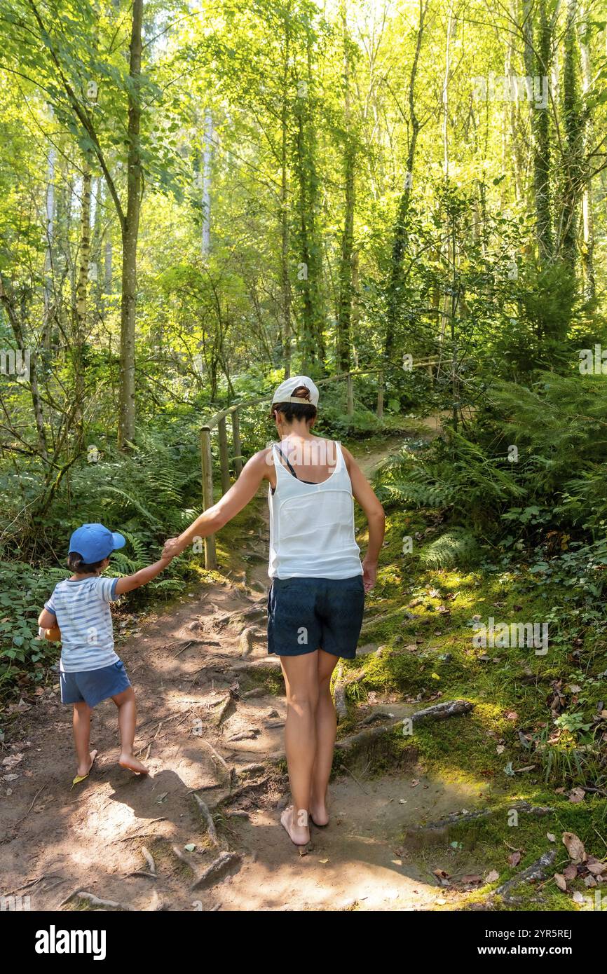 Barefoot mother and son in a sensory park to enjoy nature and the ...