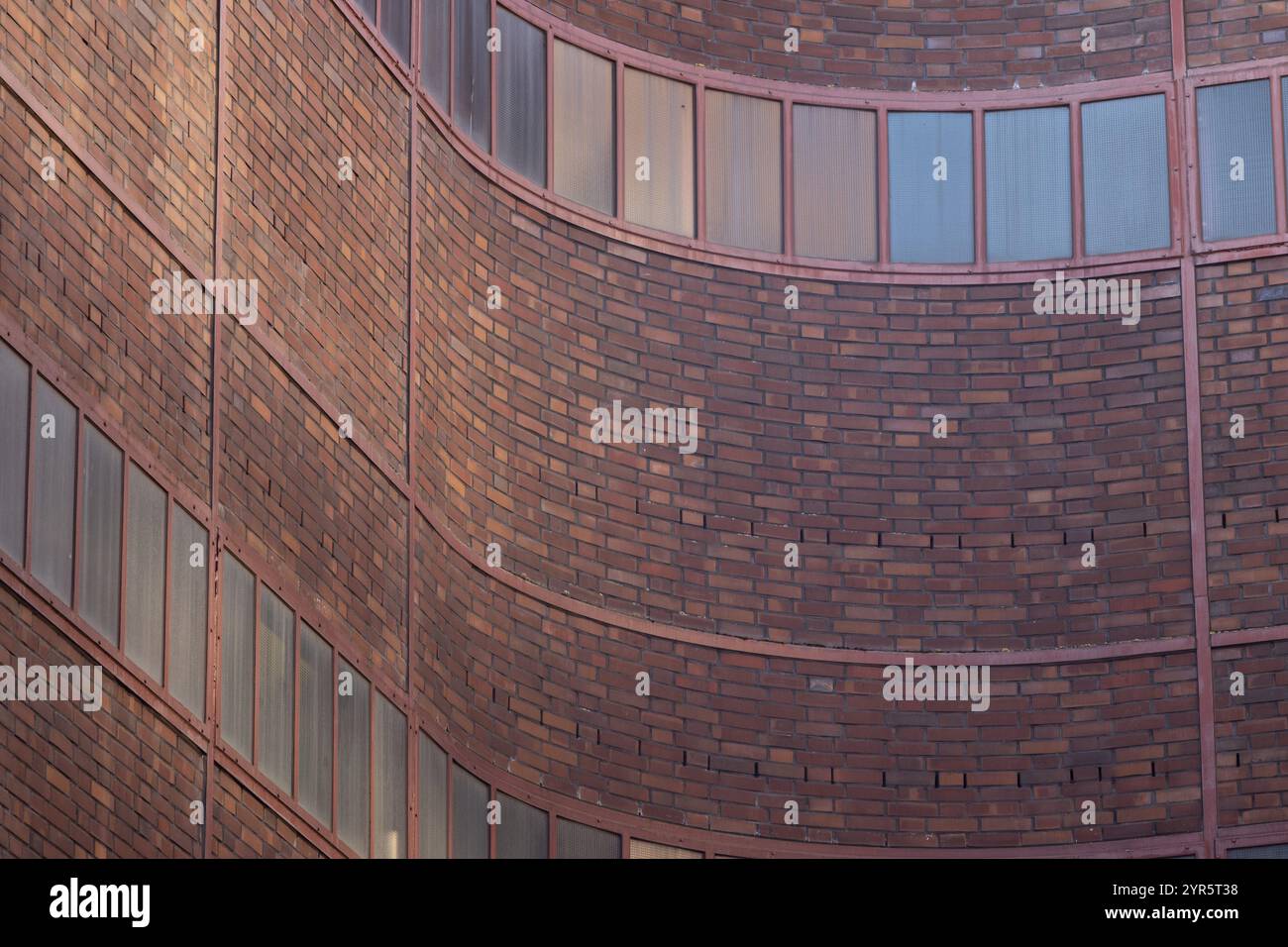 Curved brick wall section of a building with aligned windows Stock ...