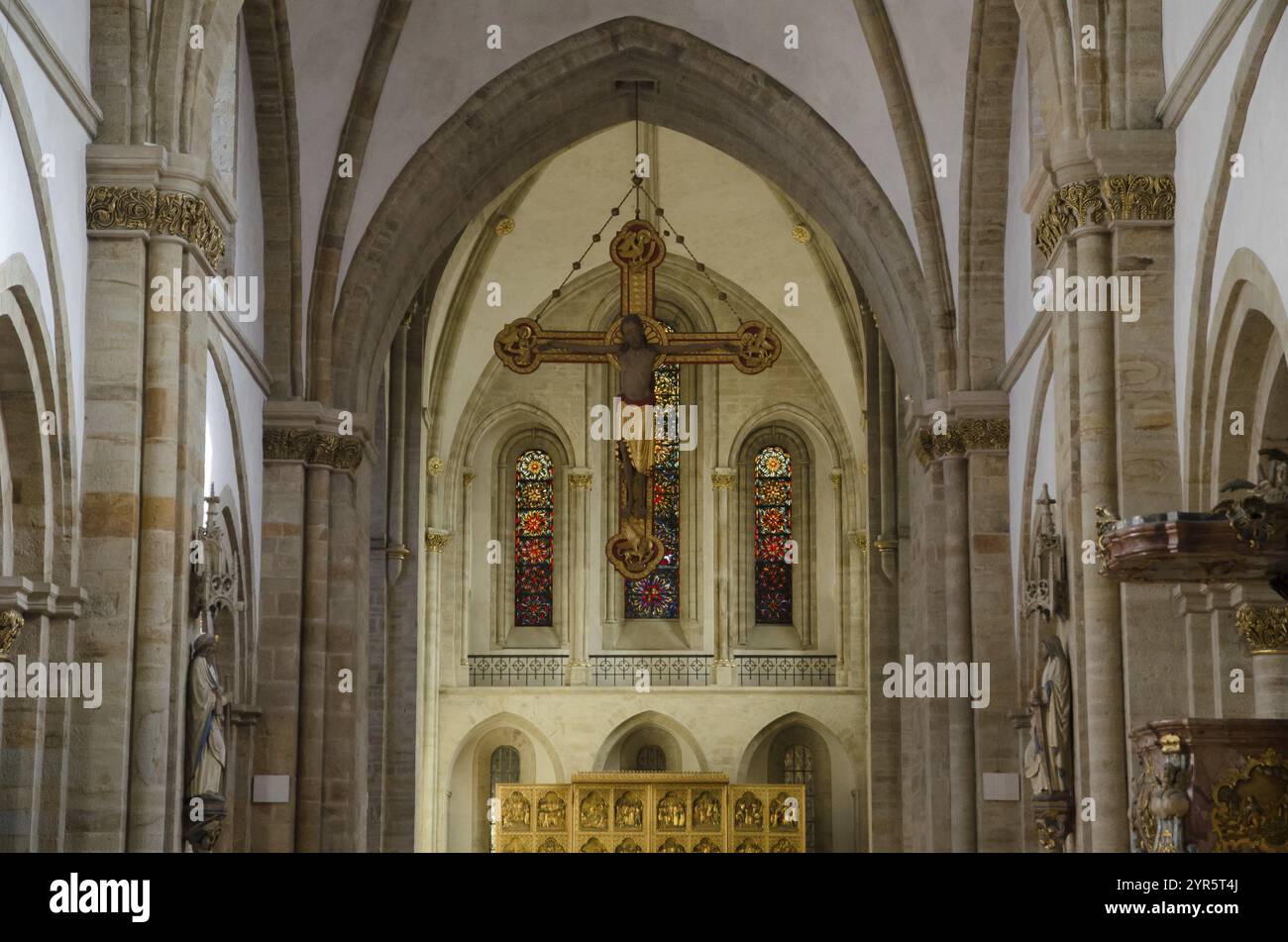 Interior of a church with cross and stained glass windows, vaulted ...