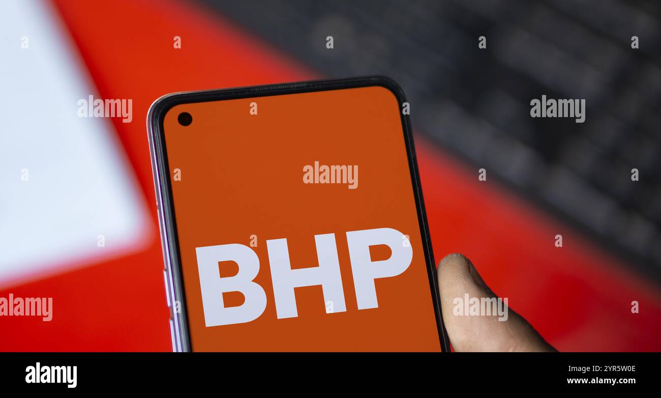 BHP logo is displayed on smartphone. BHP Group Limited is an Australian ...