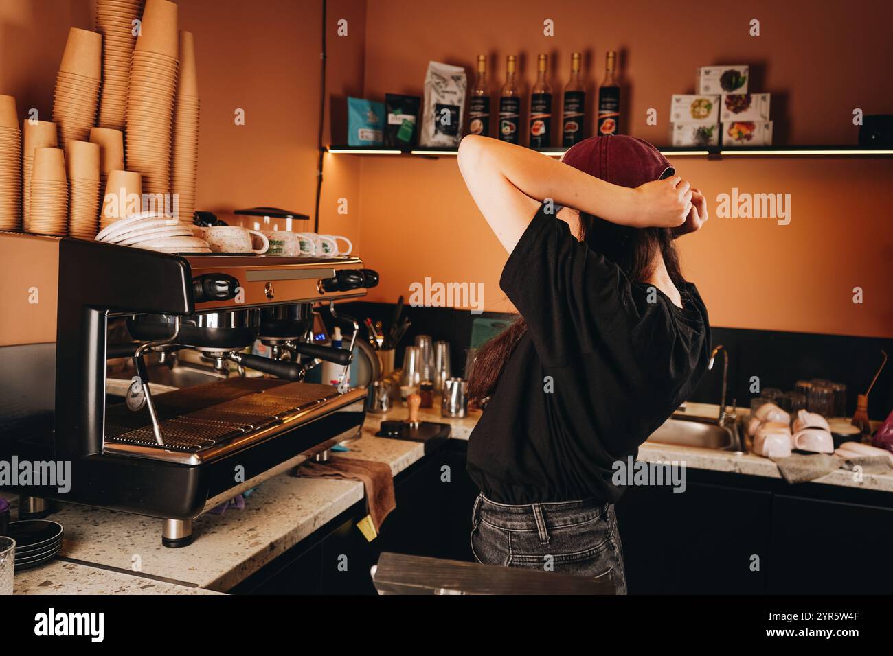 Her hands move gracefully as the barista combs her hair, her dedication ...
