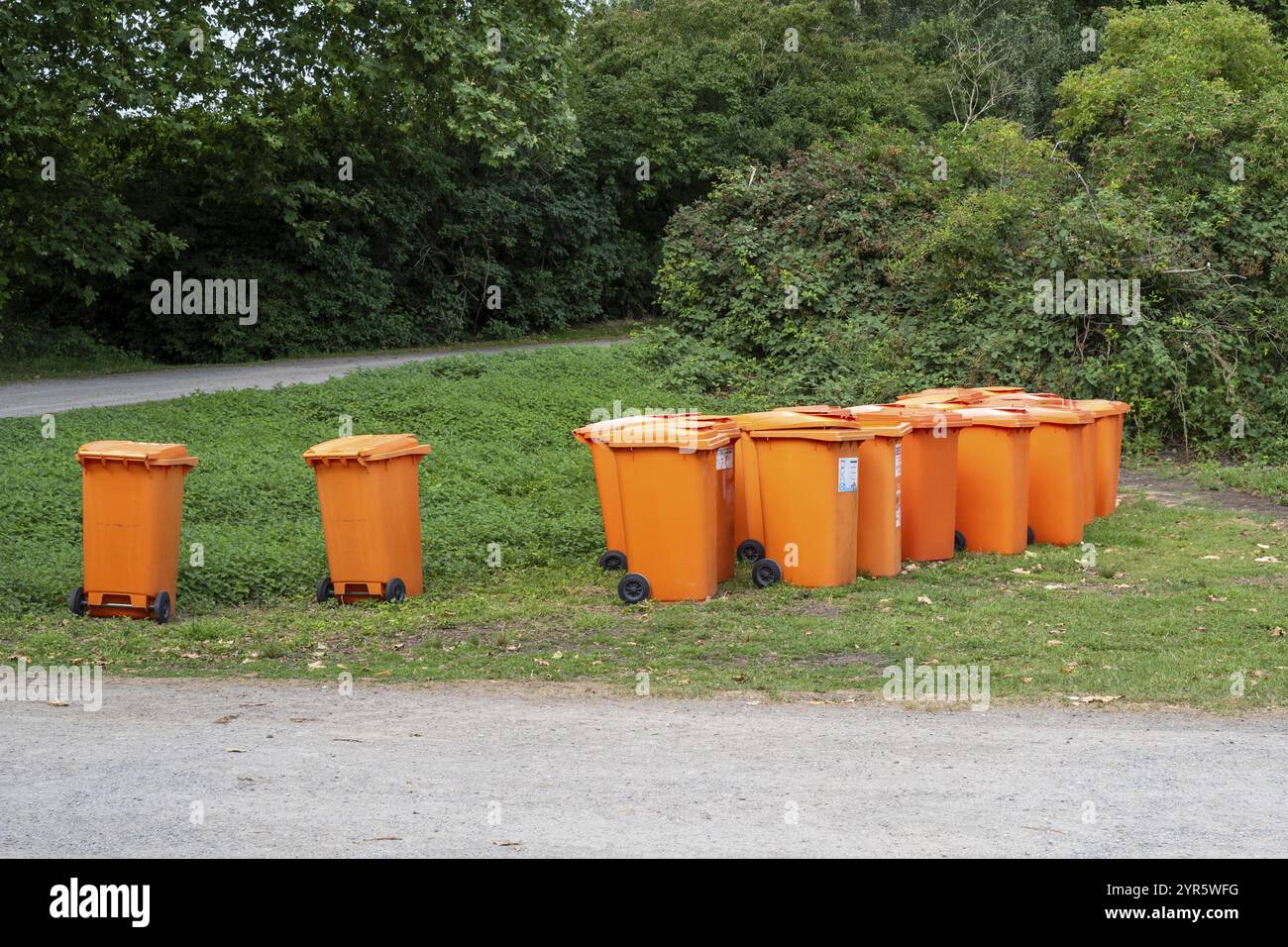 Forgotten orange mill buckets in the landscape Stock Photo - Alamy