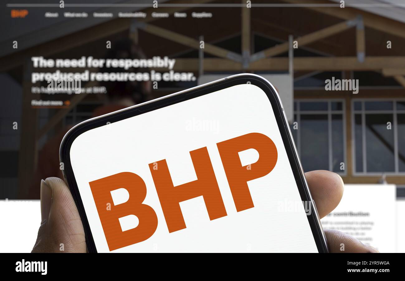 BHP logo is displayed on smartphone. BHP Group Limited is an Australian ...