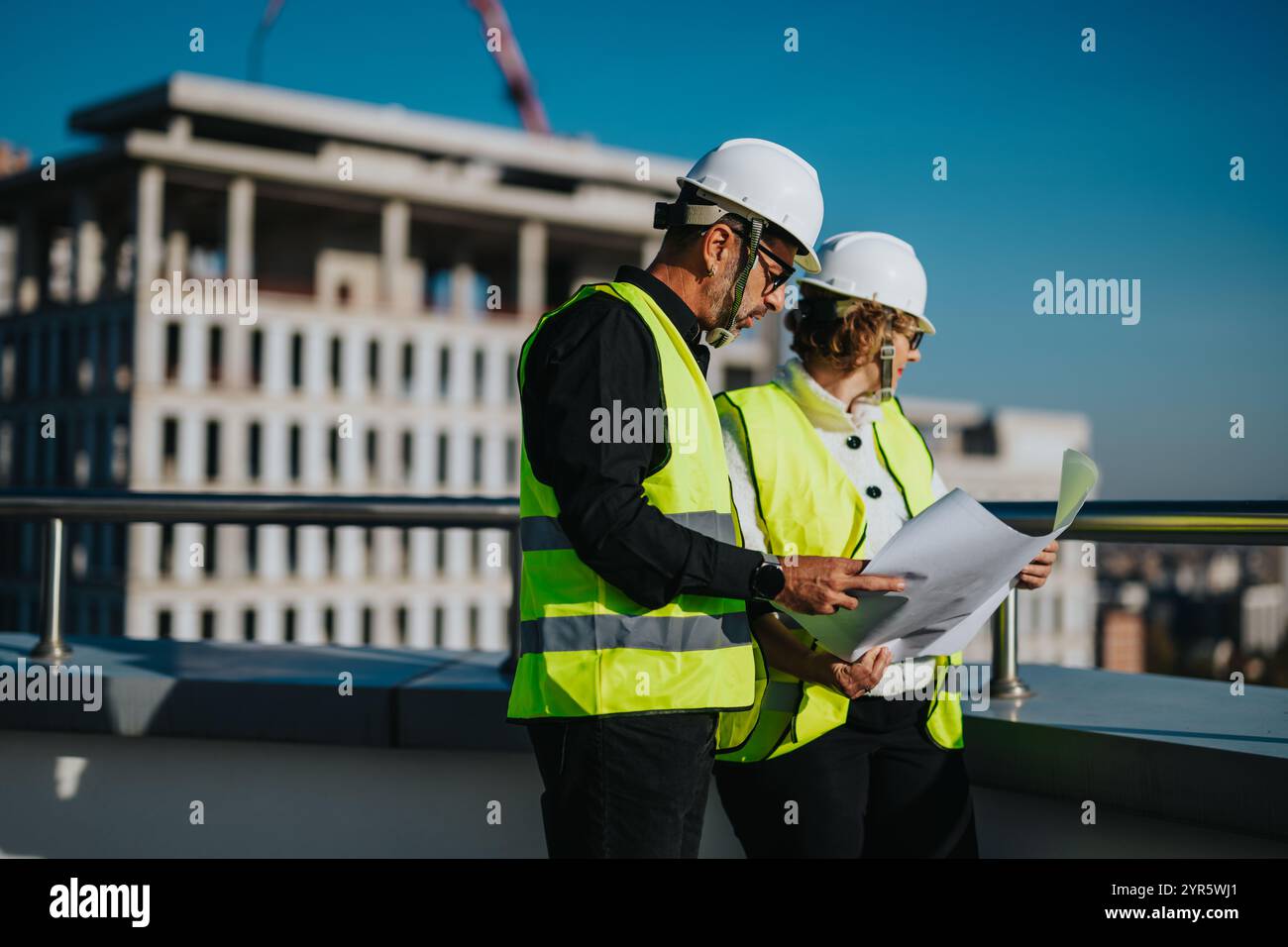 Architects discussing construction plans at a building site Stock Photo ...