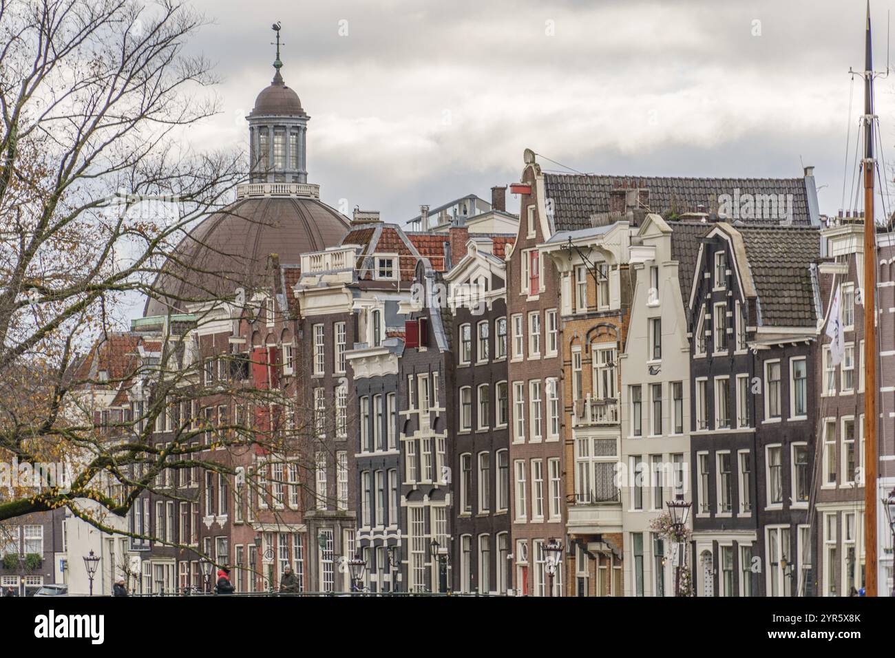Typical Dutch house facades with gables and a church in the background ...