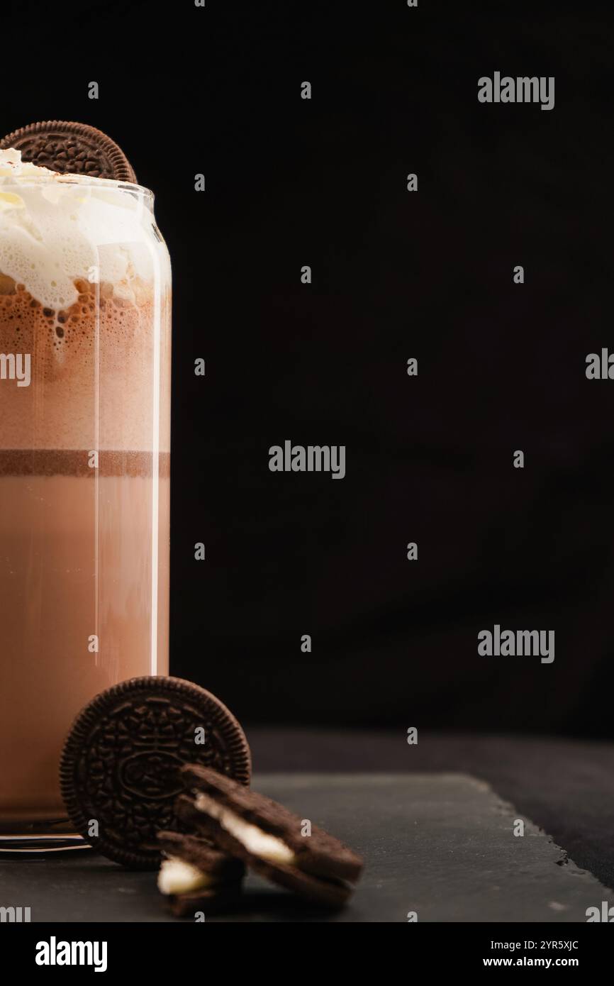 Brown chocolate milkshake in plastic cup isolated on black background ...