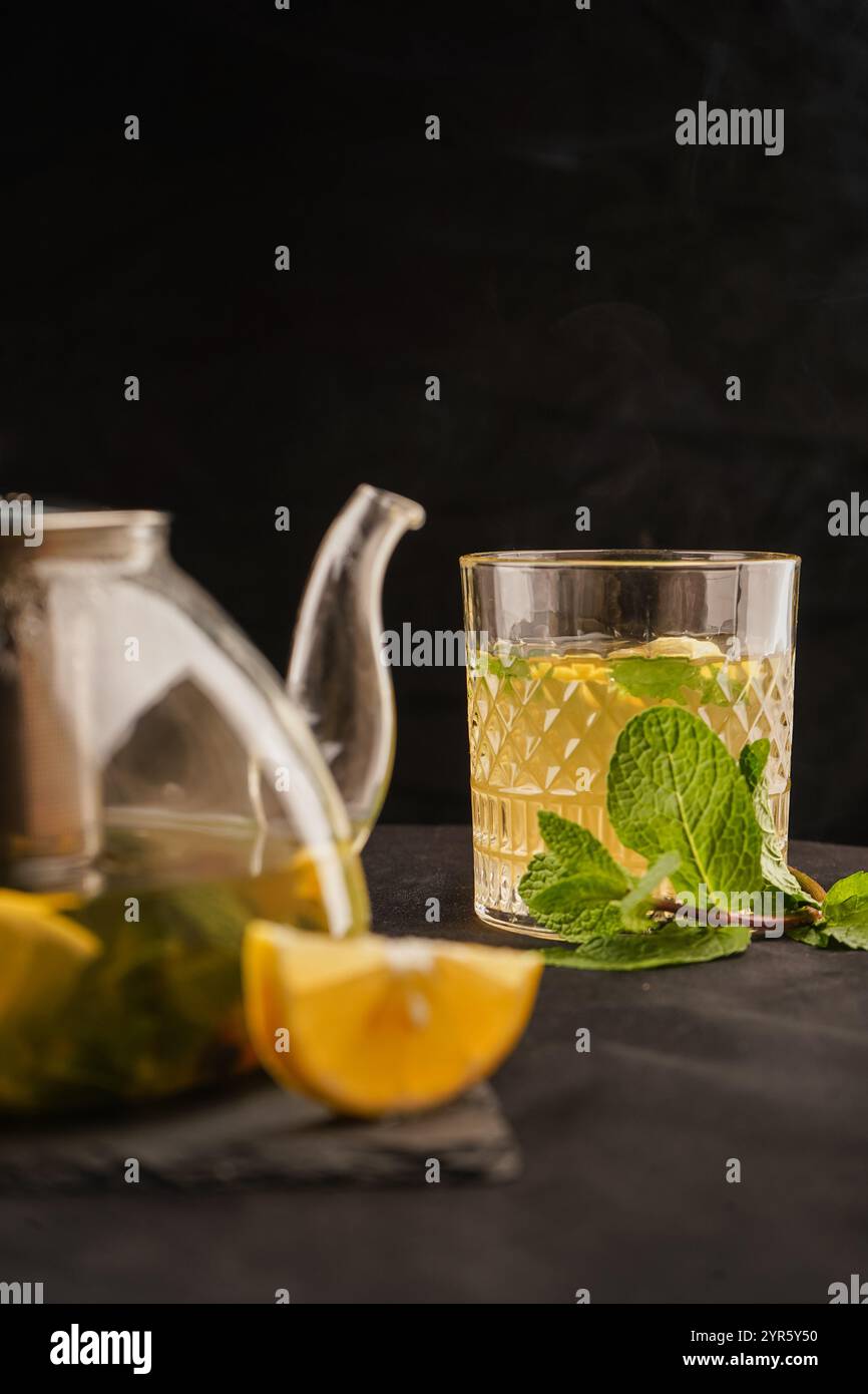 The transparent teapot reveals amber tea with a floating tea leaf that ...
