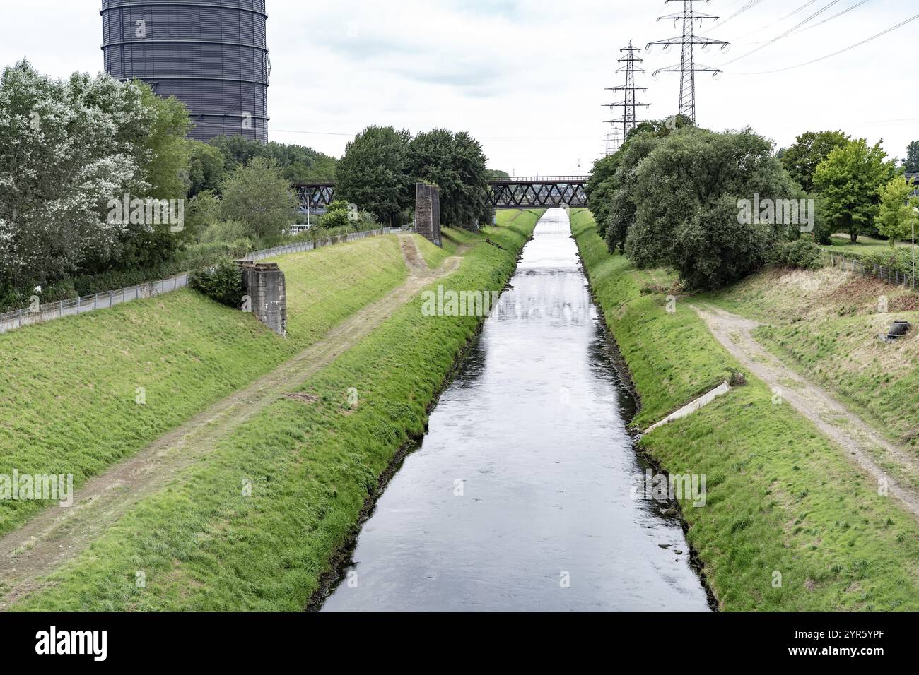 Large sewer and power lines in industrial area Stock Photo - Alamy