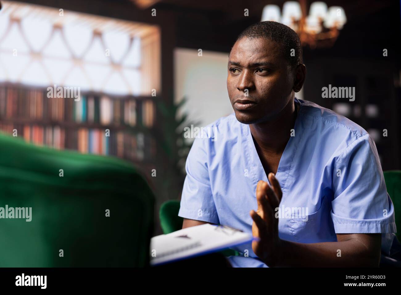 African american medical assistant in scrubs reflects on loss and ...