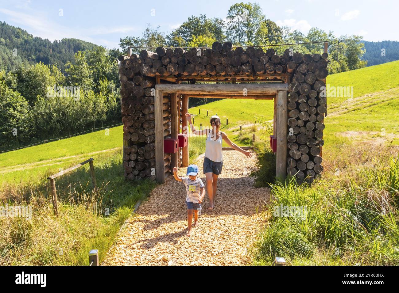 Barefoot mother and son in a sensory park to enjoy nature and the ...