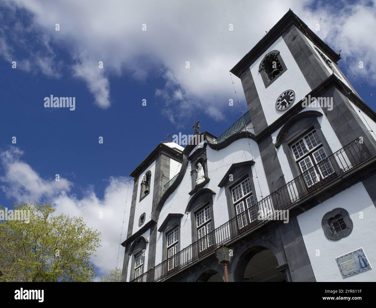 The facade of a church with two towers against a clear sky, funchal ...