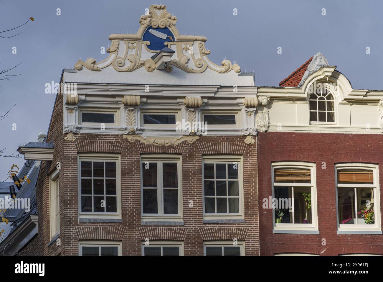 Decorated facade of a historic brick house with windows, Amsterdam ...