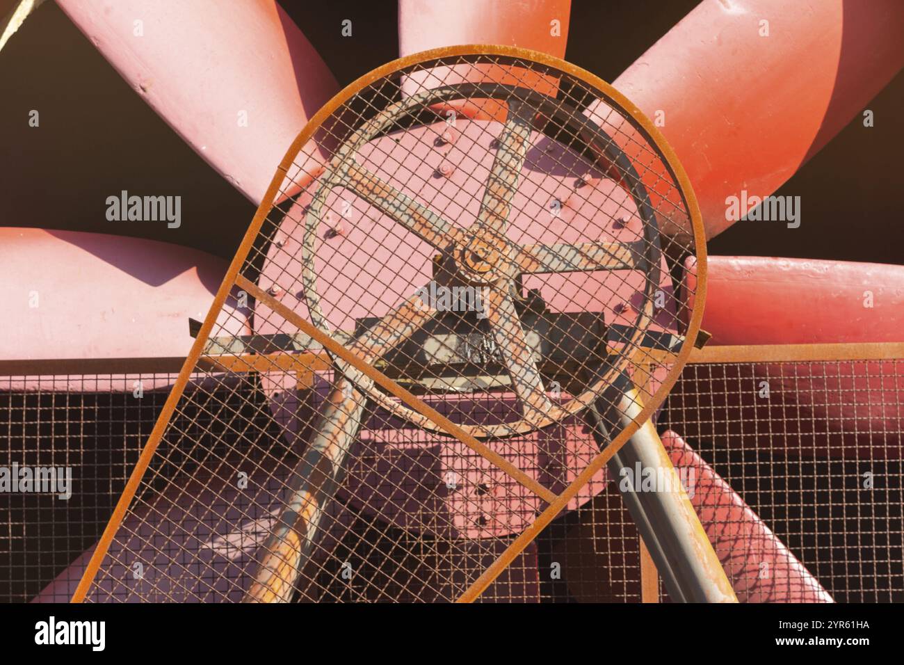 Large industrial fan with red blades and protective mesh cover Stock ...