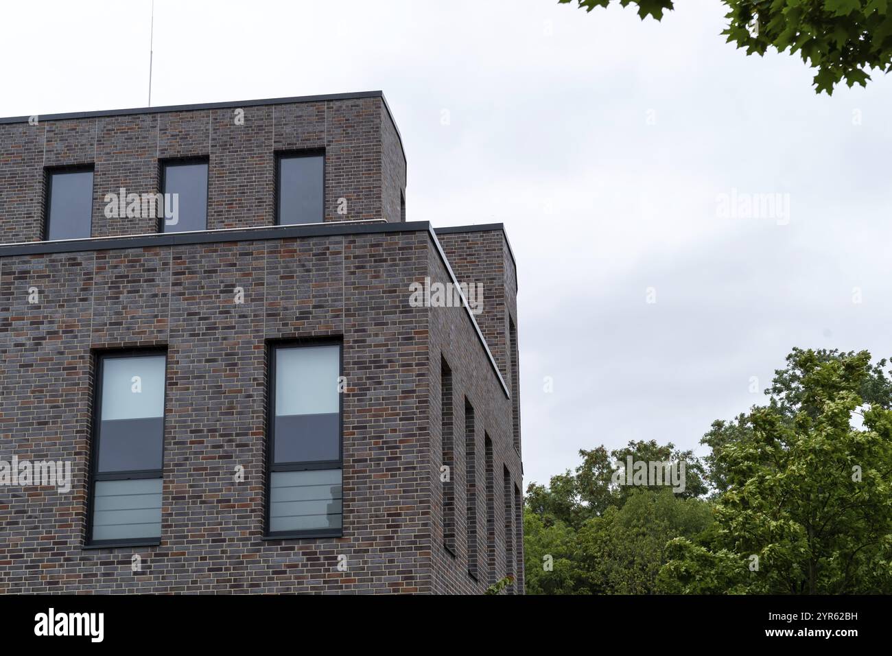 Modern brick building with grey sky Stock Photo - Alamy