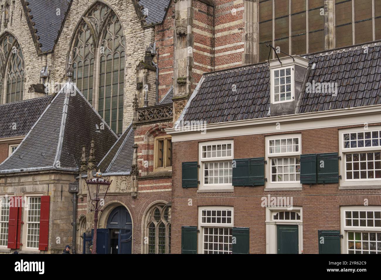 Detailed view of a historic building next to a large church with Gothic ...