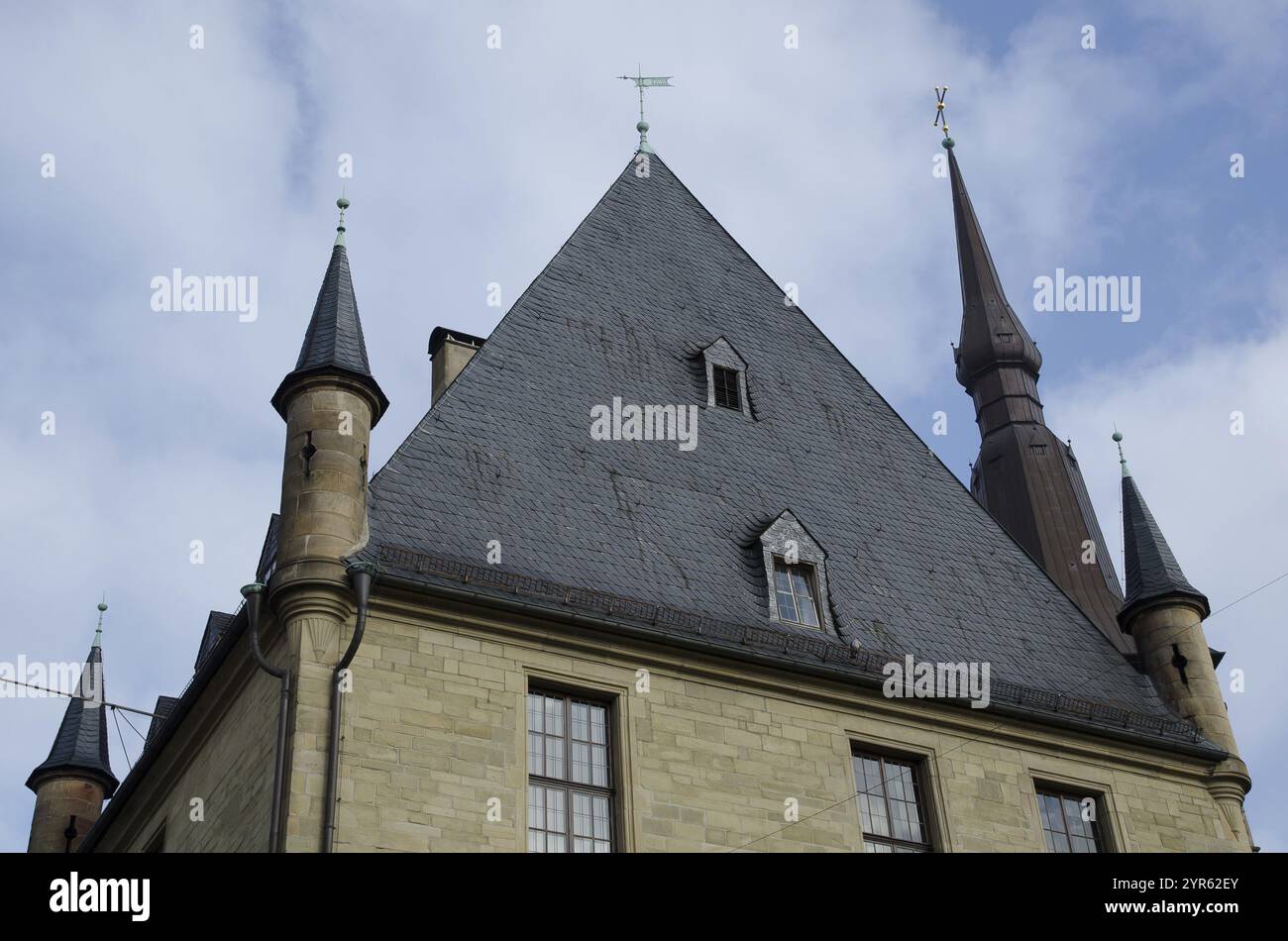 Historic building with slate-covered roof and decorative turrets ...
