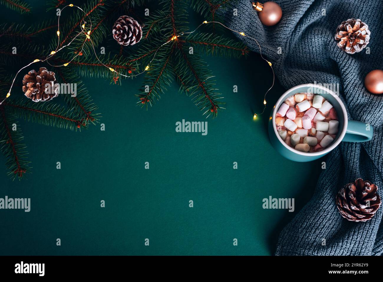 Hot chocolate with marshmallows, pine cones, and string lights on a ...