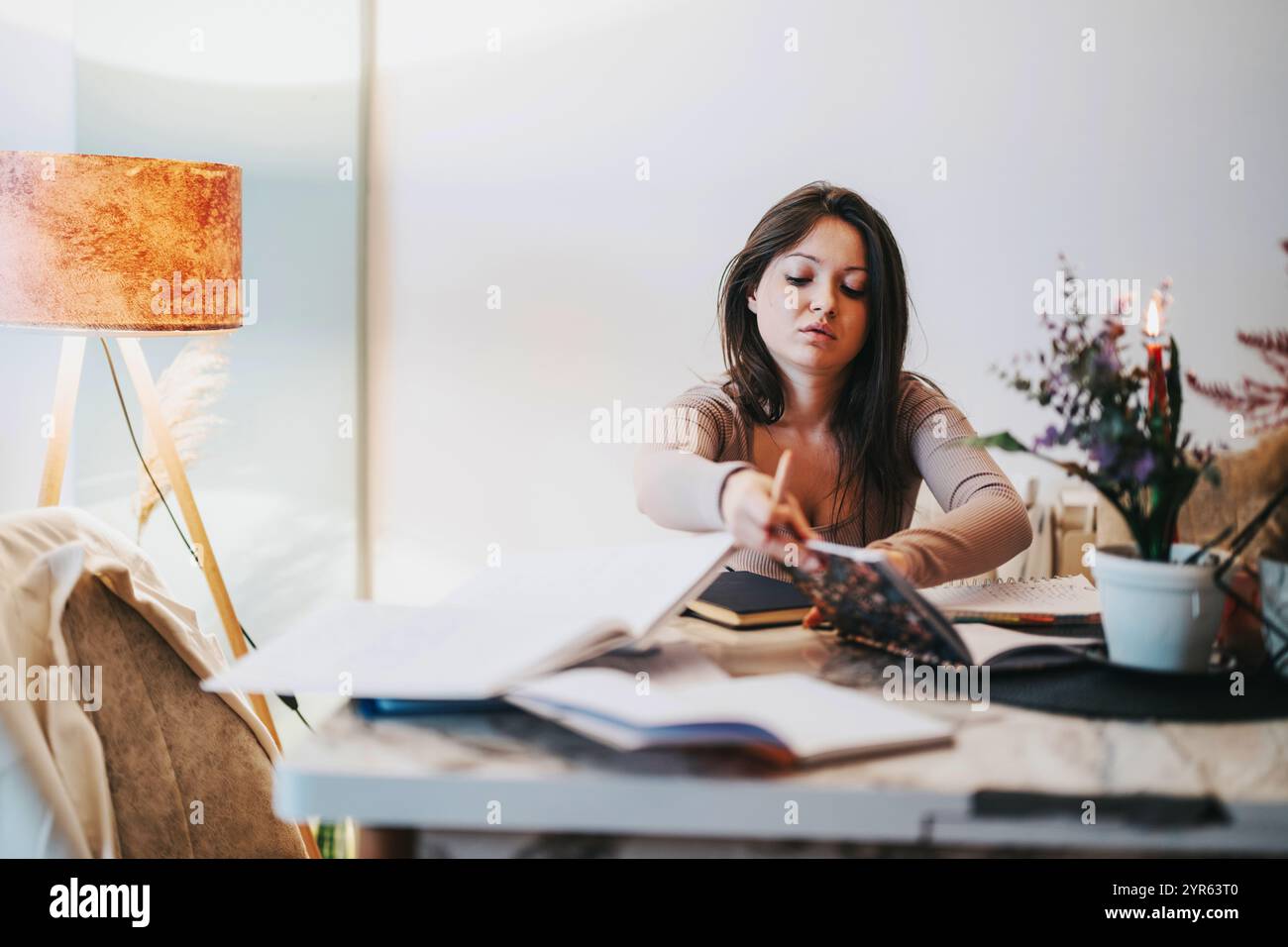College student studying at home with focus and dedication Stock Photo ...