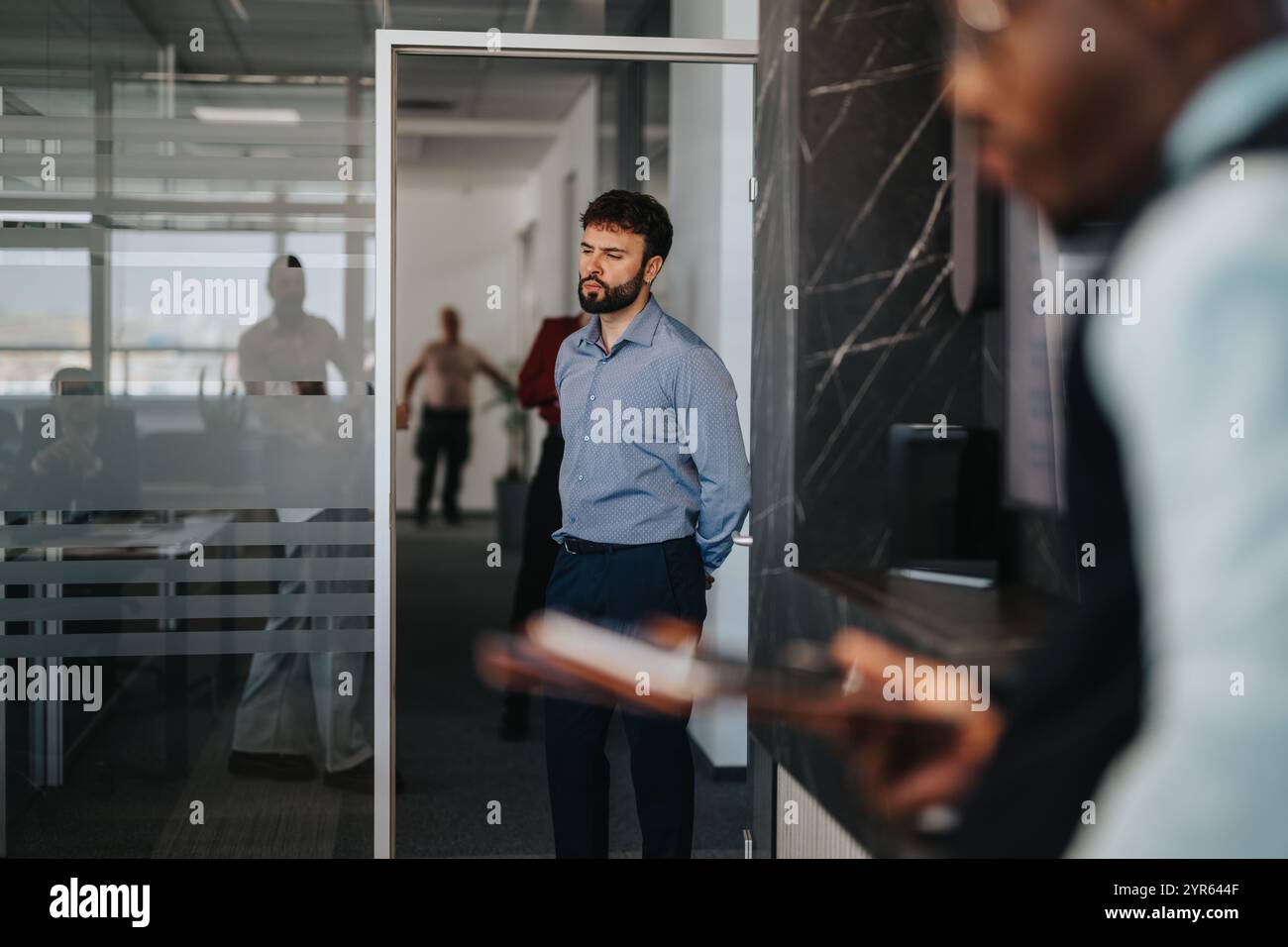 Multiracial people in an office hallway conversation Stock Photo - Alamy