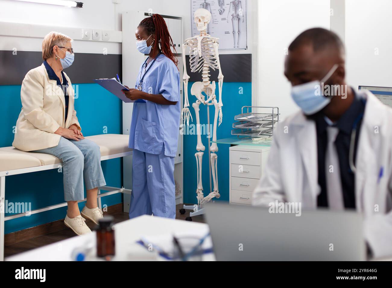 Female doctor assistant with clipboard is questioning retired patient ...
