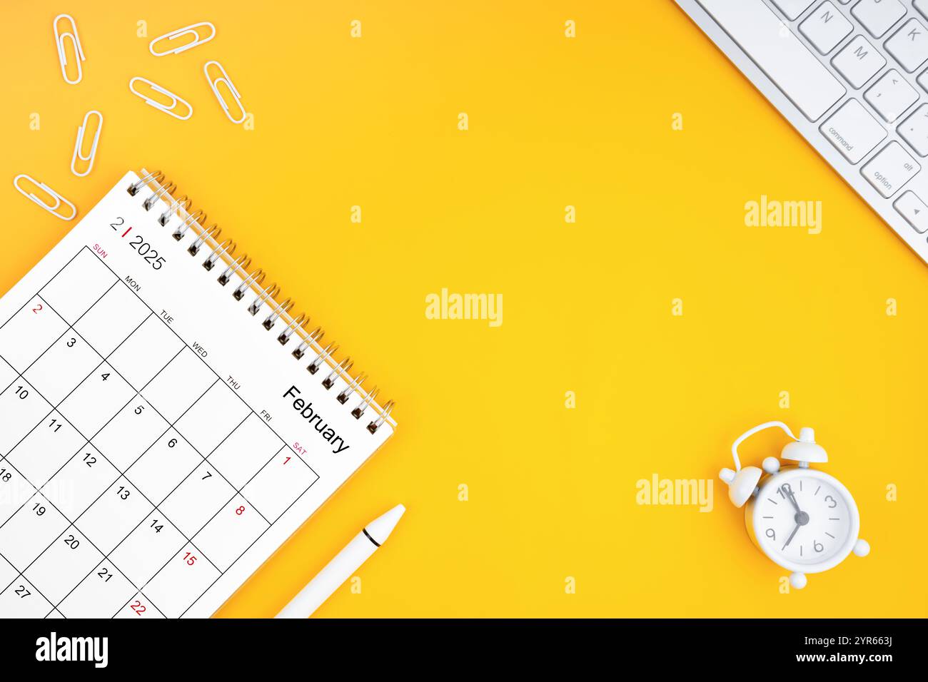 February 2025, Monthly desk calendar for 2025 year and alarm clock with ...